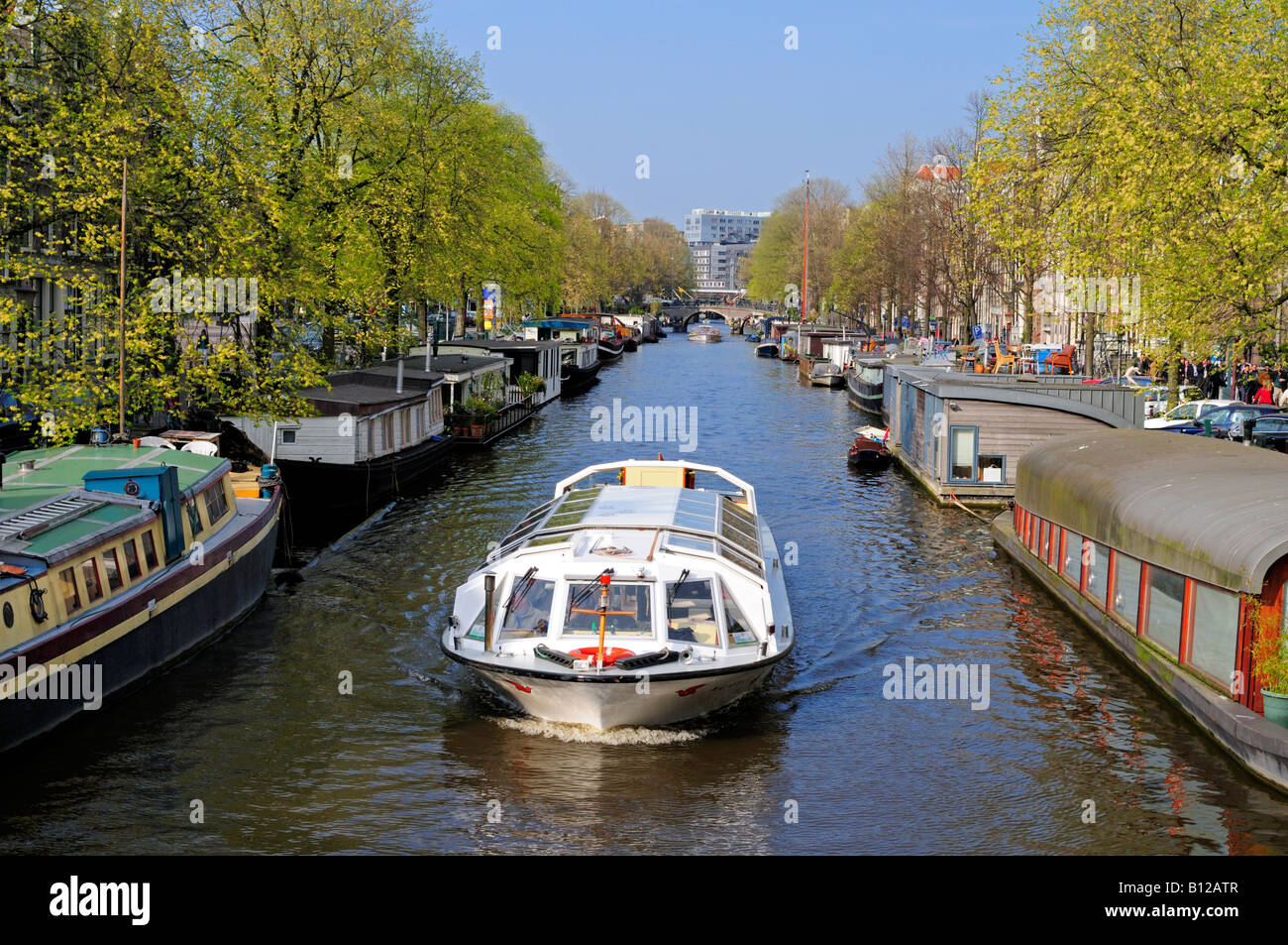 A tour boat on a canal Amsterdam Holland The Netherlands Europe Stock ...