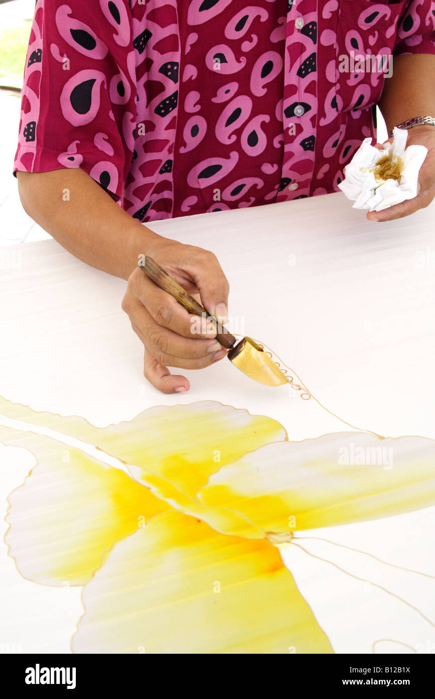 Batik painting closeup hand holding canting Stock Photo - Alamy