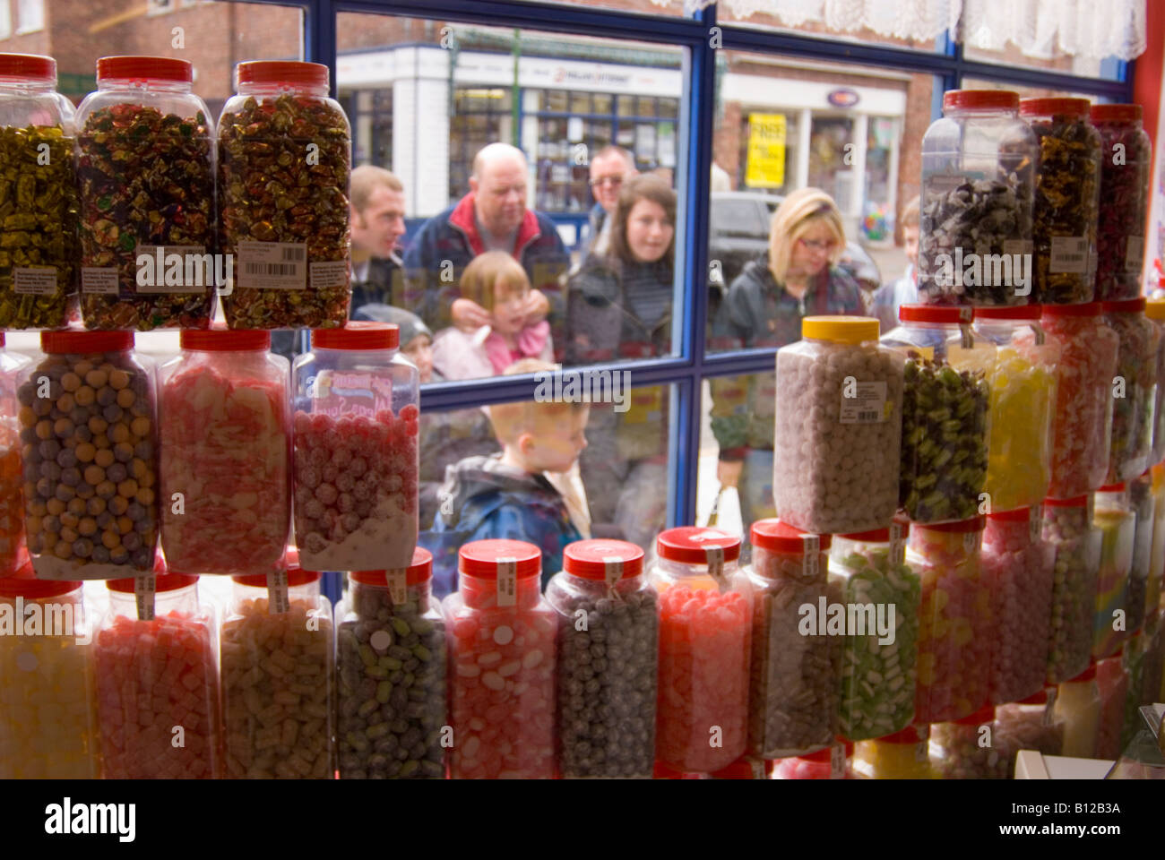 People Looking Through The Window Of A Traditional English Sweet Shop ...
