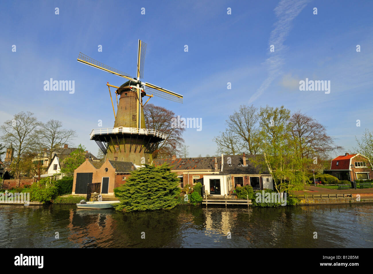 Traditional Dutch windmill along canal Holland Europe Stock Photo - Alamy