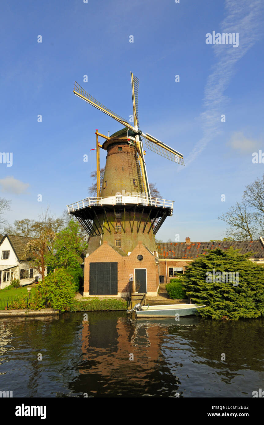 Traditional Dutch windmill at canal Holland Europe Stock Photo - Alamy