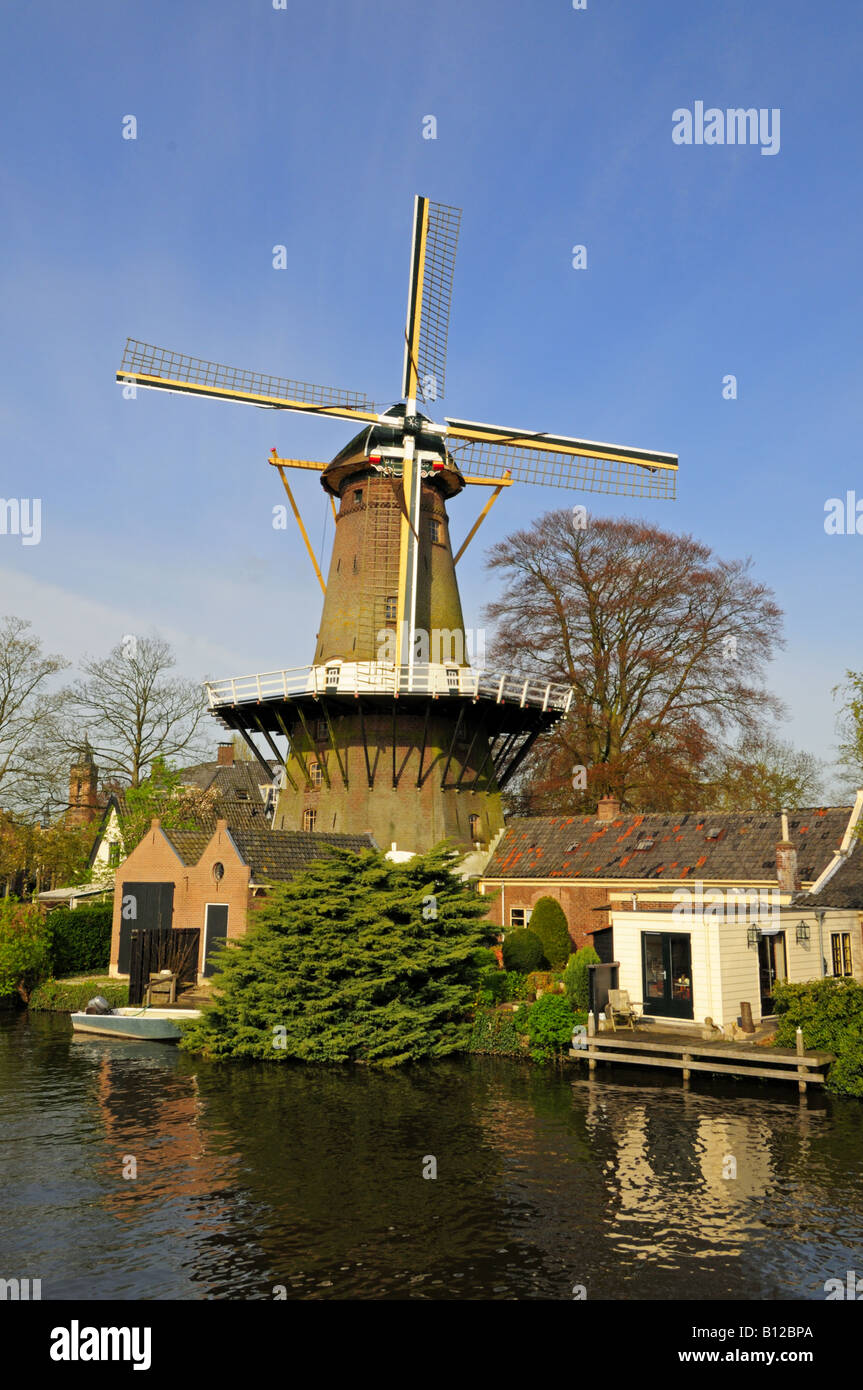 Traditional Dutch windmill along canal Holland Europe Stock Photo - Alamy
