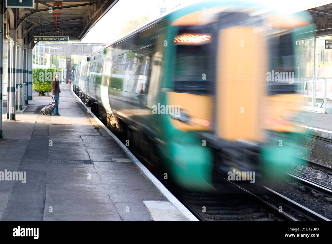 A train rushes passed at a south London station Stock Photo - Alamy