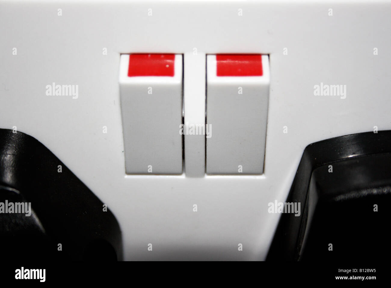 Two plugs turned on in the plug sockets Stock Photo - Alamy