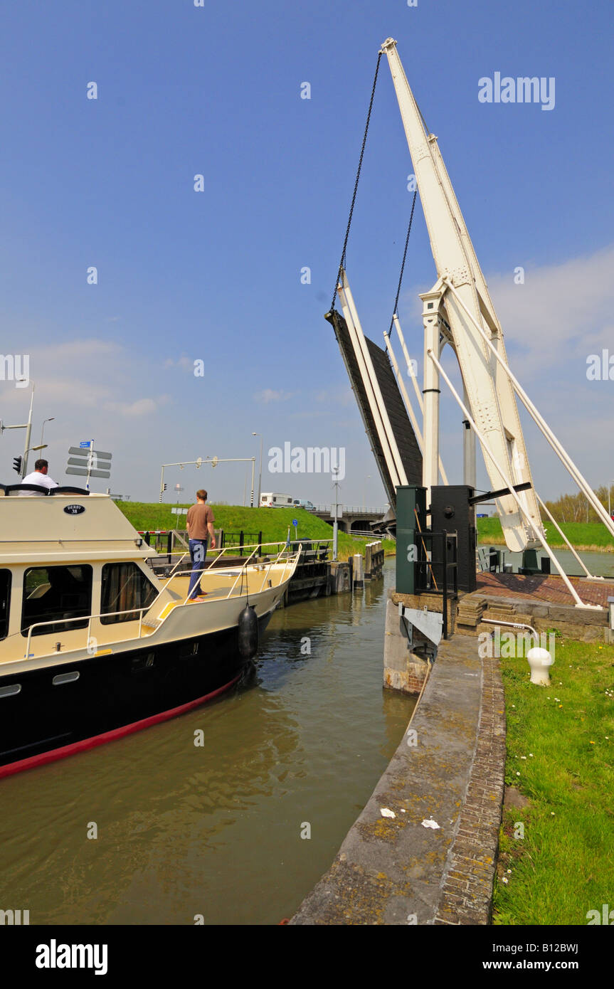 Yacht passing through open bridge on Dutch canal Holland Europe Stock ...