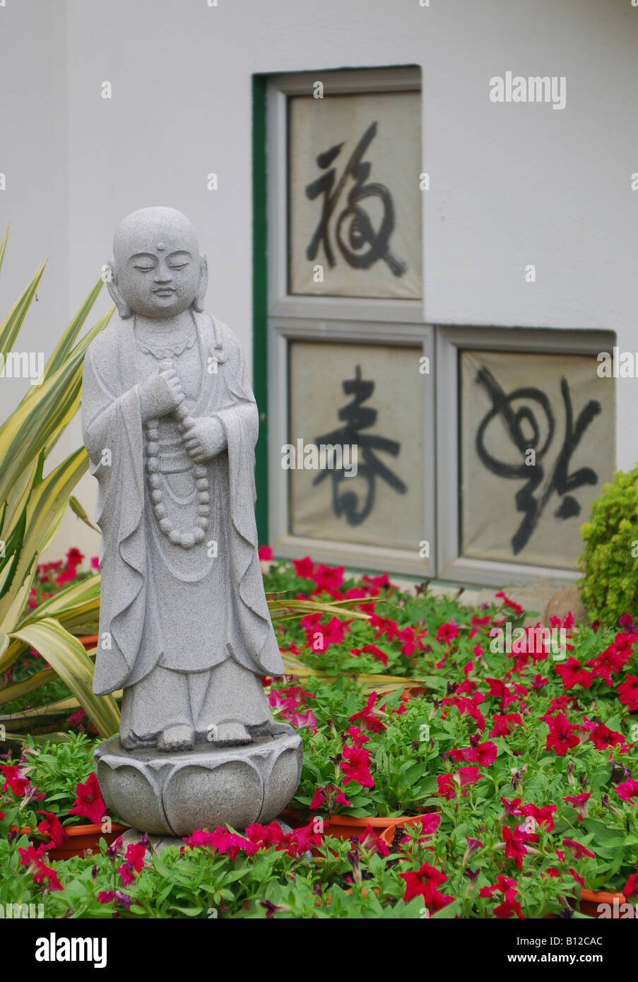 Stone statue of monk Stock Photo - Alamy