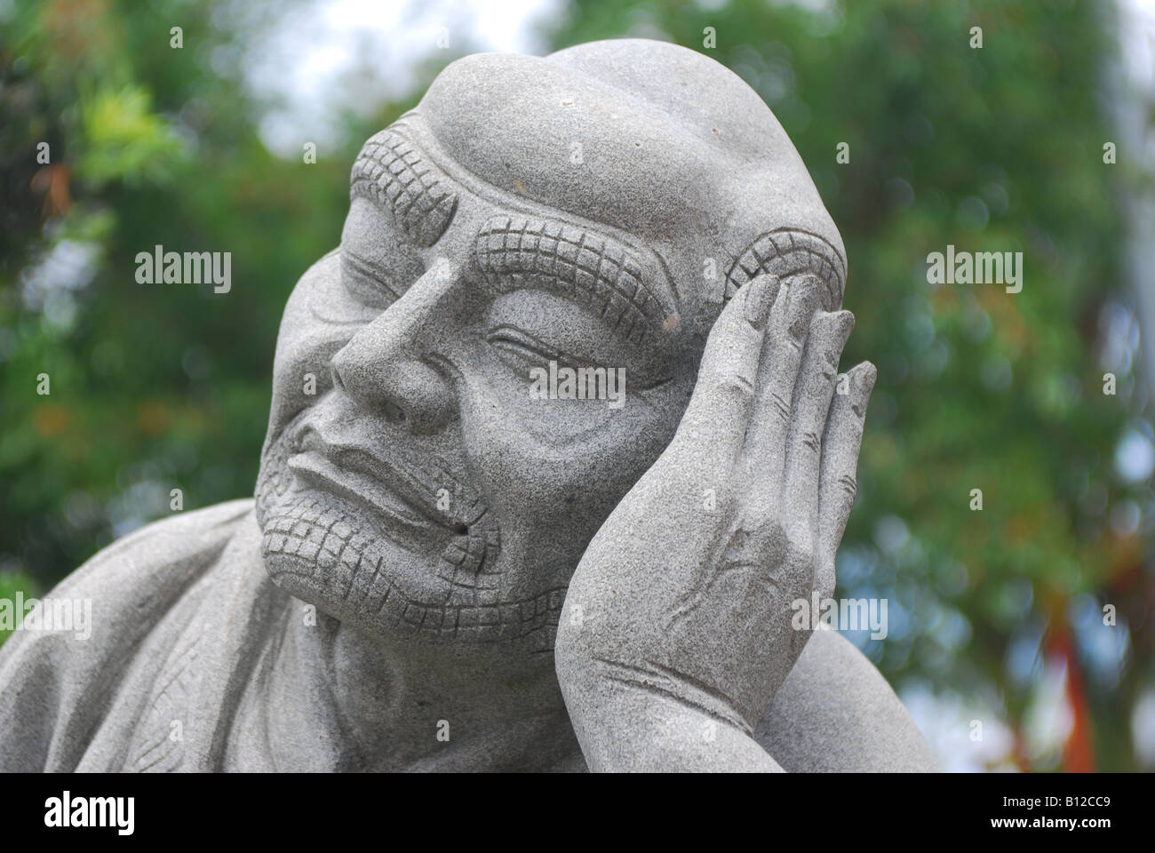 Stone sculpture of monk in meditation Stock Photo - Alamy