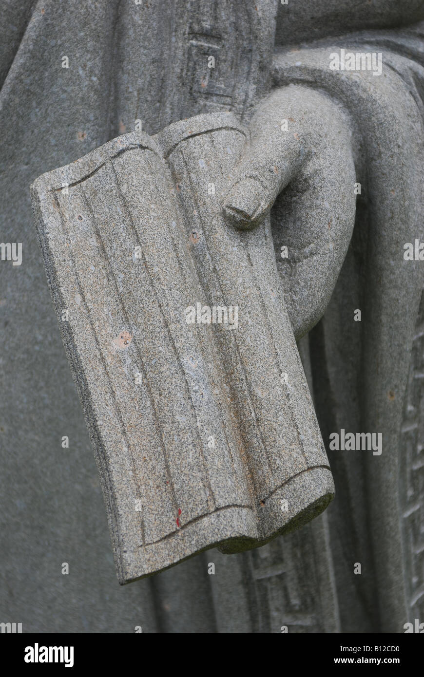 Stone sculpture hand holding book Stock Photo - Alamy