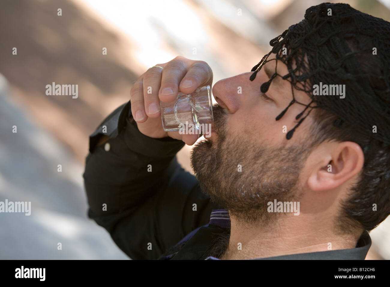 One Cretan man drinking a shot of Cretan traditional tsikoudia spirit ...