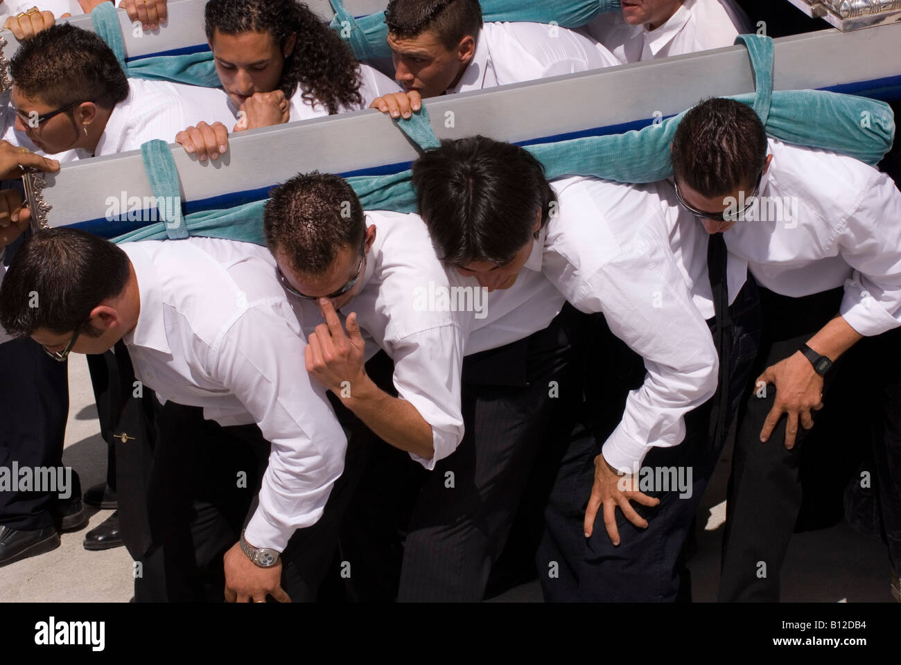 Young men prepare to raise an effigy of the Virgin Mary during Semanta ...