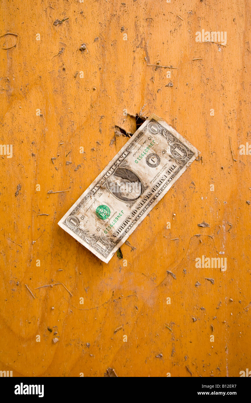 Dollar bill stuck to the door of a bathroom destroyed by a tornado in ...