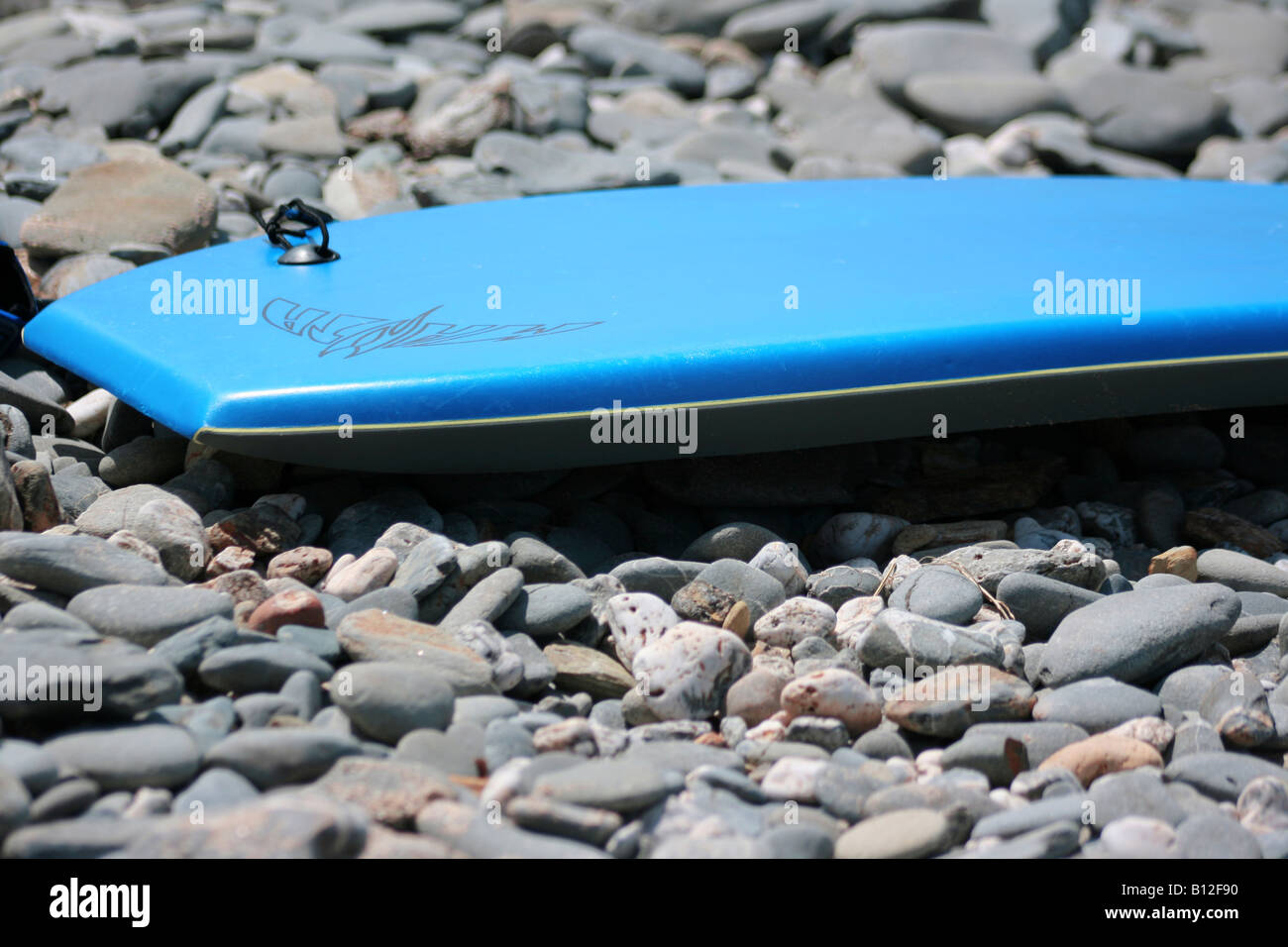 A body board on a pebbled beach Stock Photo - Alamy