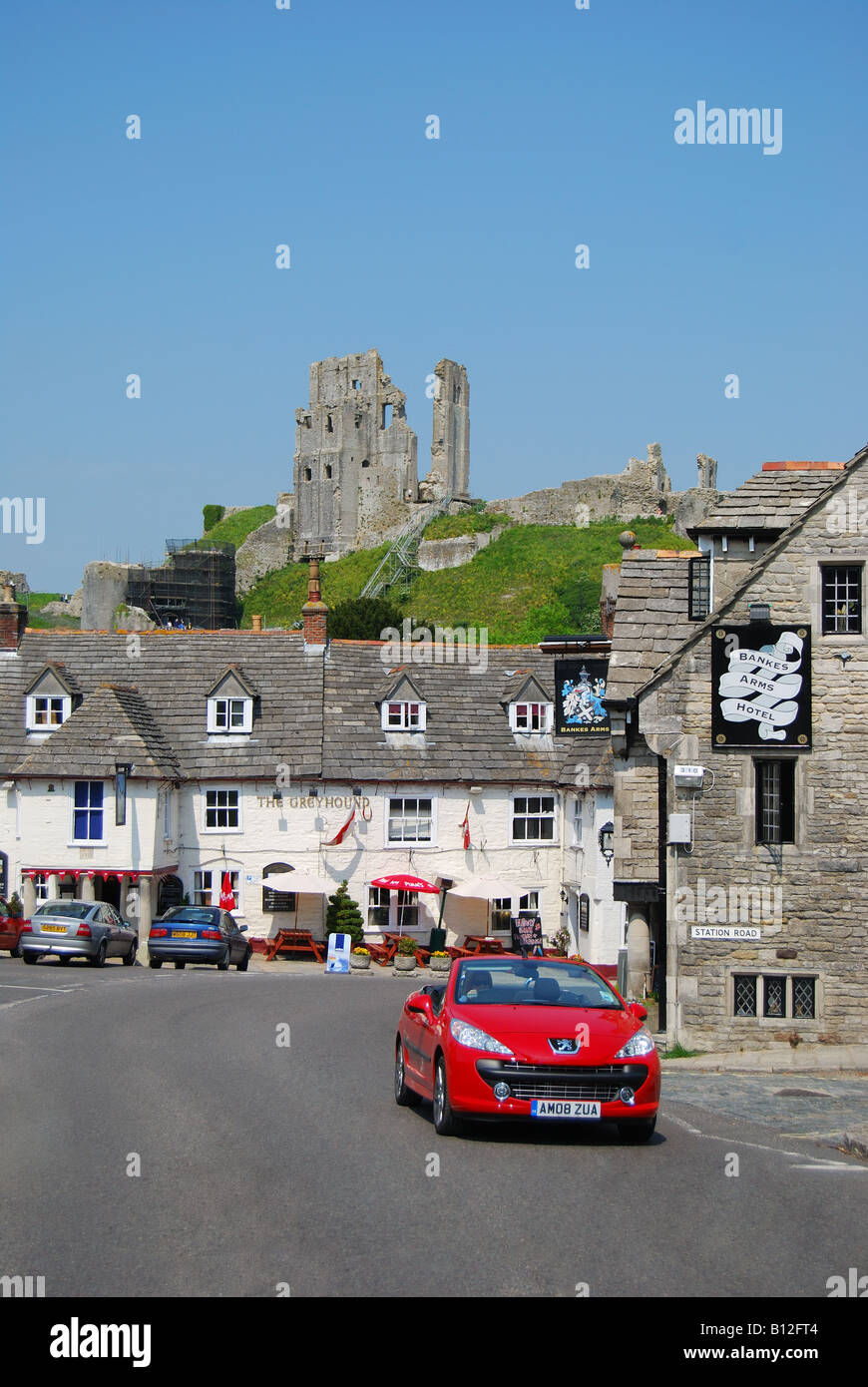 Car driving through village, Corfe Castle, Dorset, England, United ...
