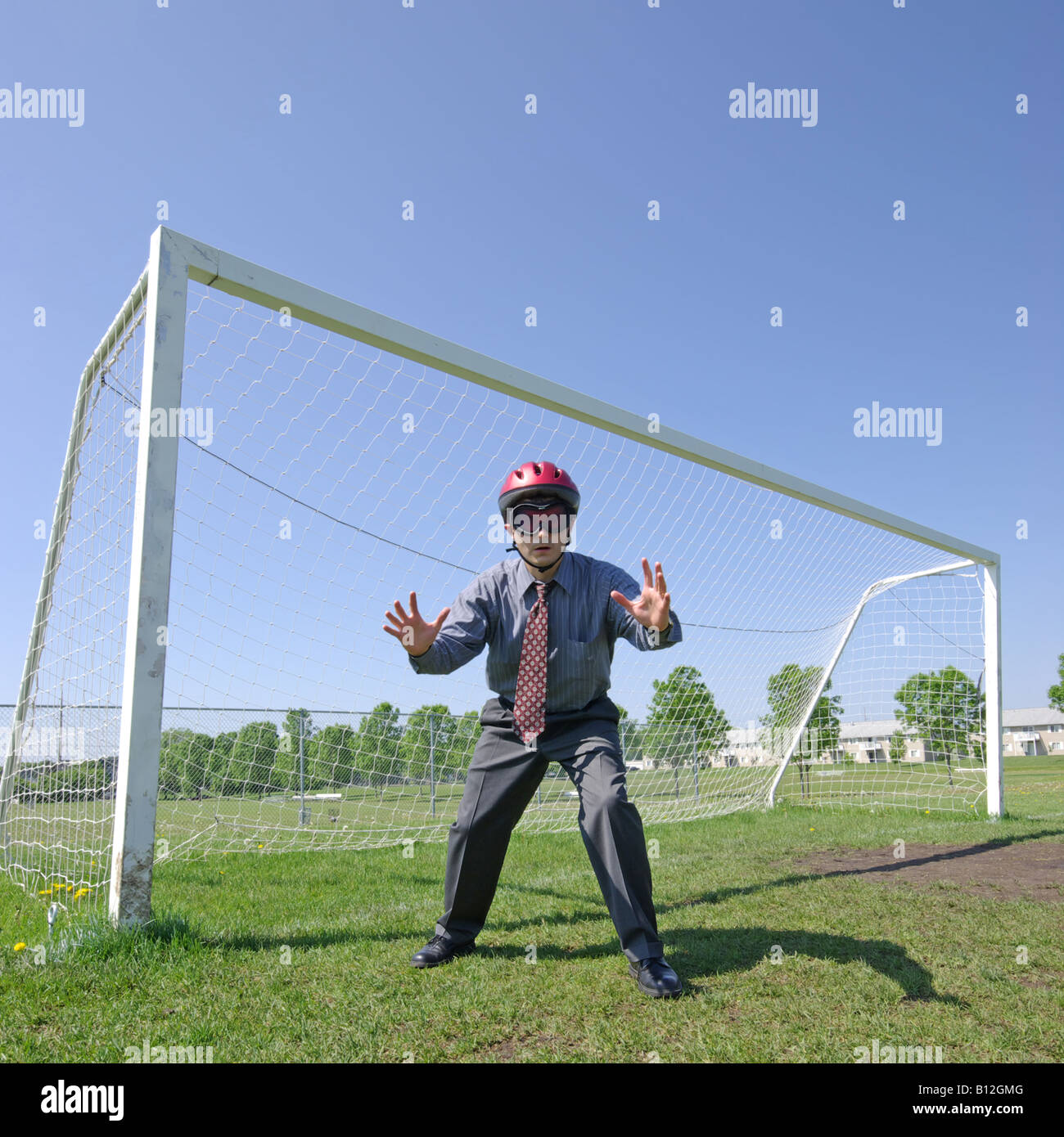 Business man defending soccer goal, concept Stock Photo - Alamy