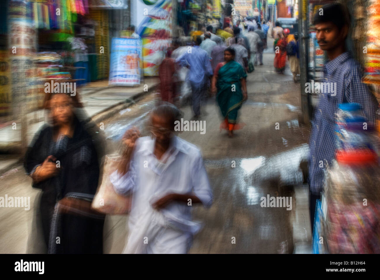 Tiruchirappalli, India, panned motion of shoppers at the local market ...