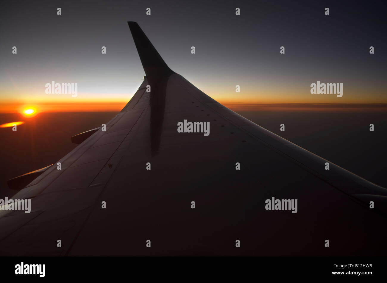BOEING 737 700 WING SUNSET GLOW Stock Photo - Alamy