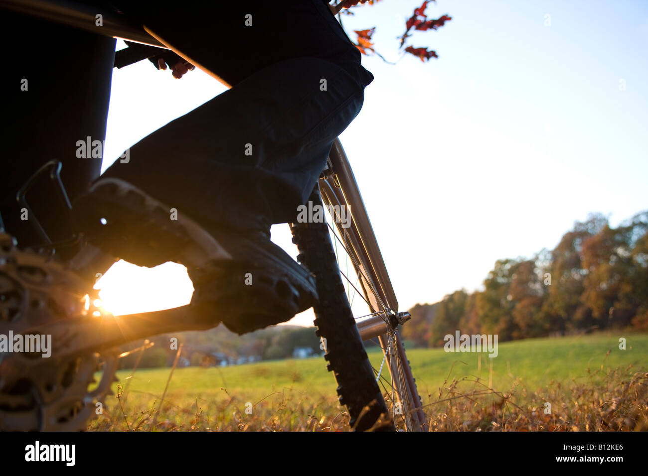 WOMAN RIDING BIKE ALONE OUTDOORS ON BICYCLE Stock Photo - Alamy