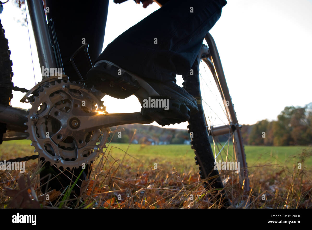 WOMAN RIDING BIKE ALONE OUTDOORS ON BICYCLE Stock Photo - Alamy