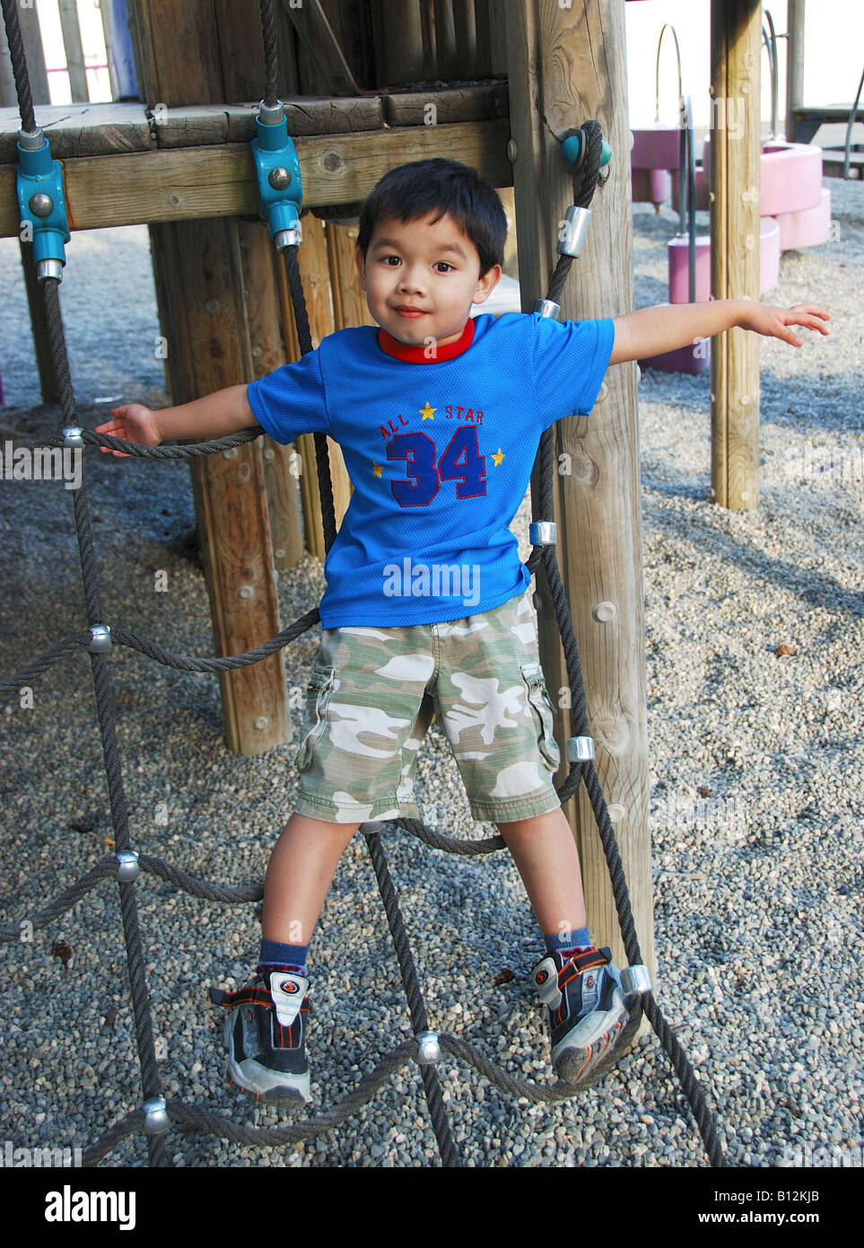 Boy playing in the playground Stock Photo - Alamy