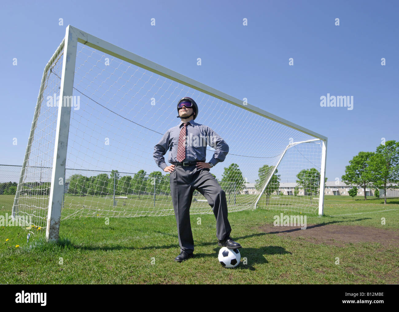 Business man defending soccer goal, concept Stock Photo - Alamy