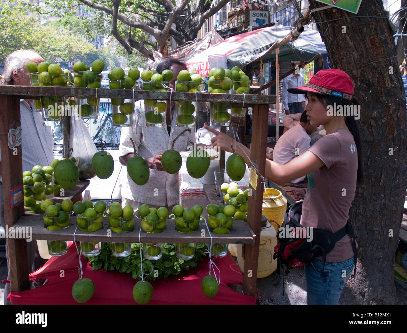 tourist buying a mango from street vendor in Calcutta Stock Photo - Alamy