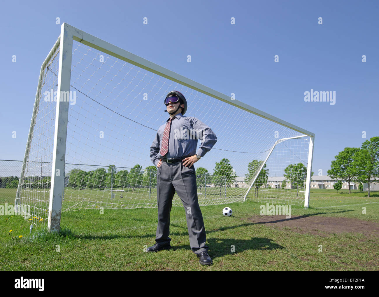 Business man defending soccer goal, concept Stock Photo - Alamy