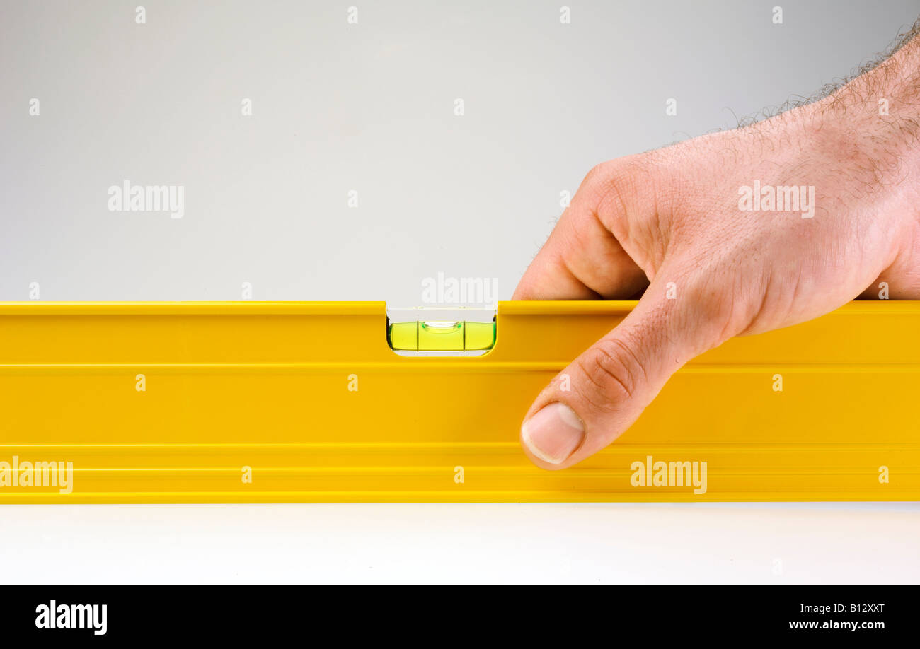 MAN HOLDING SPIRIT LEVEL Stock Photo - Alamy
