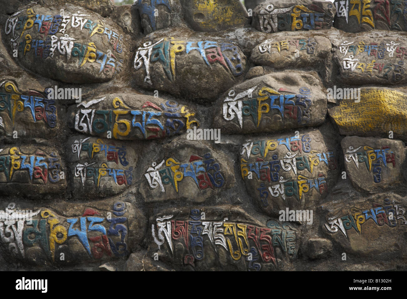 Prayers carved and painted onto stone wall kathmandu nepal Stock Photo ...