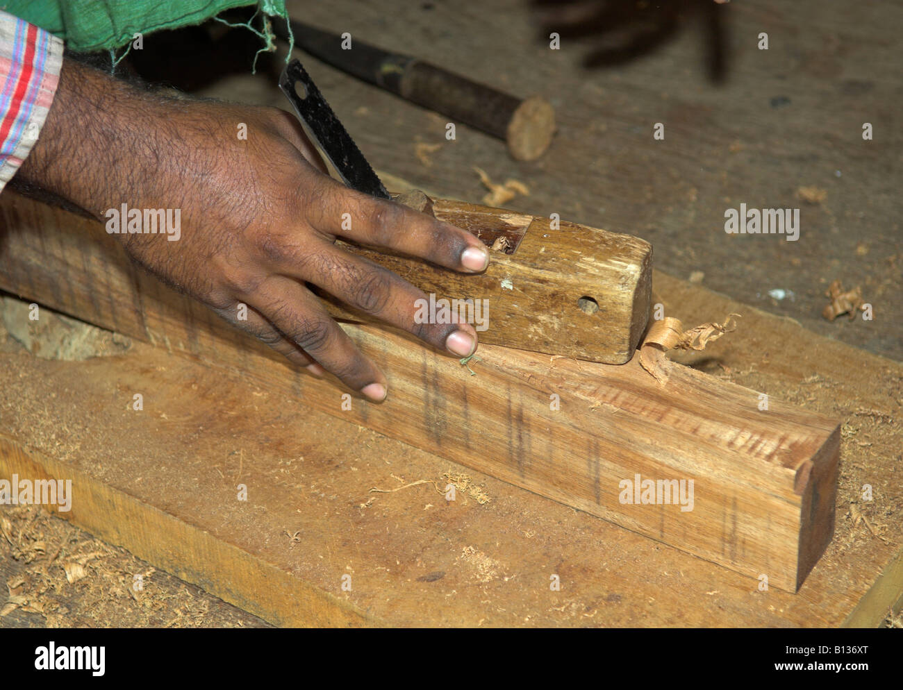 Closeup of Indian carpenter using a wooden plane, Kumarakom, Kerala ...