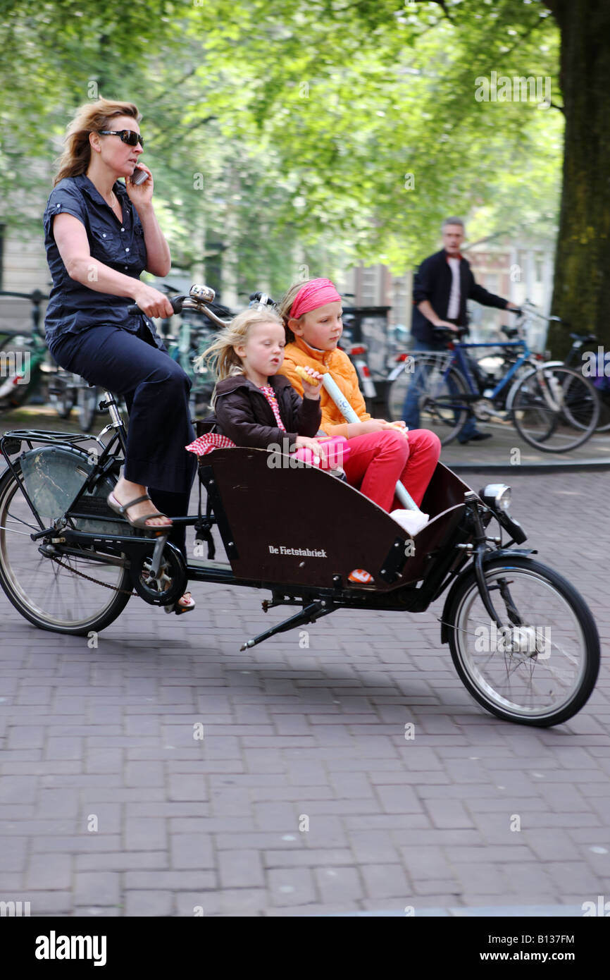 Small family going to kindergarten, by bike Stock Photo - Alamy