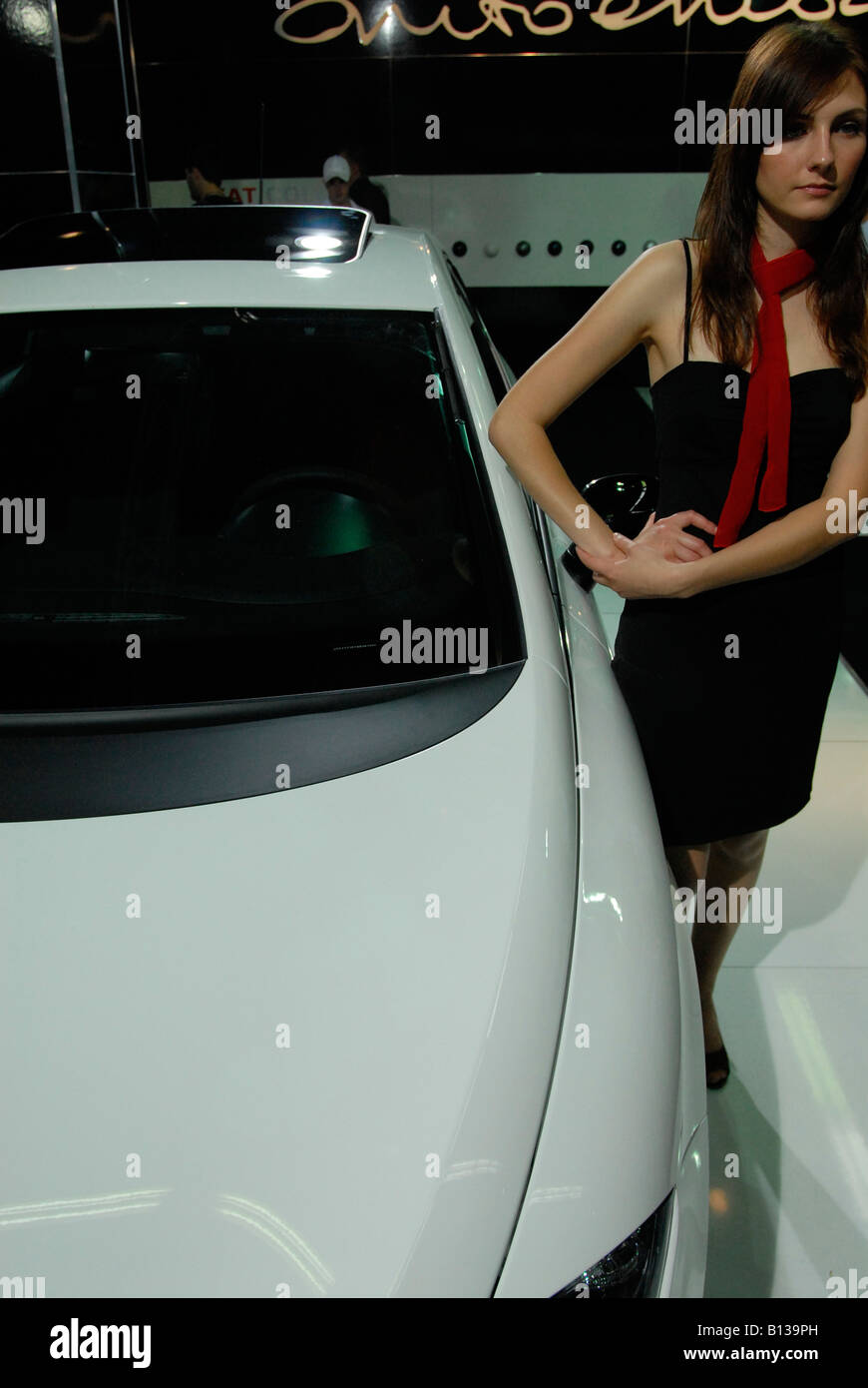 Israel New model cars on display at a car show Young female presenter ...