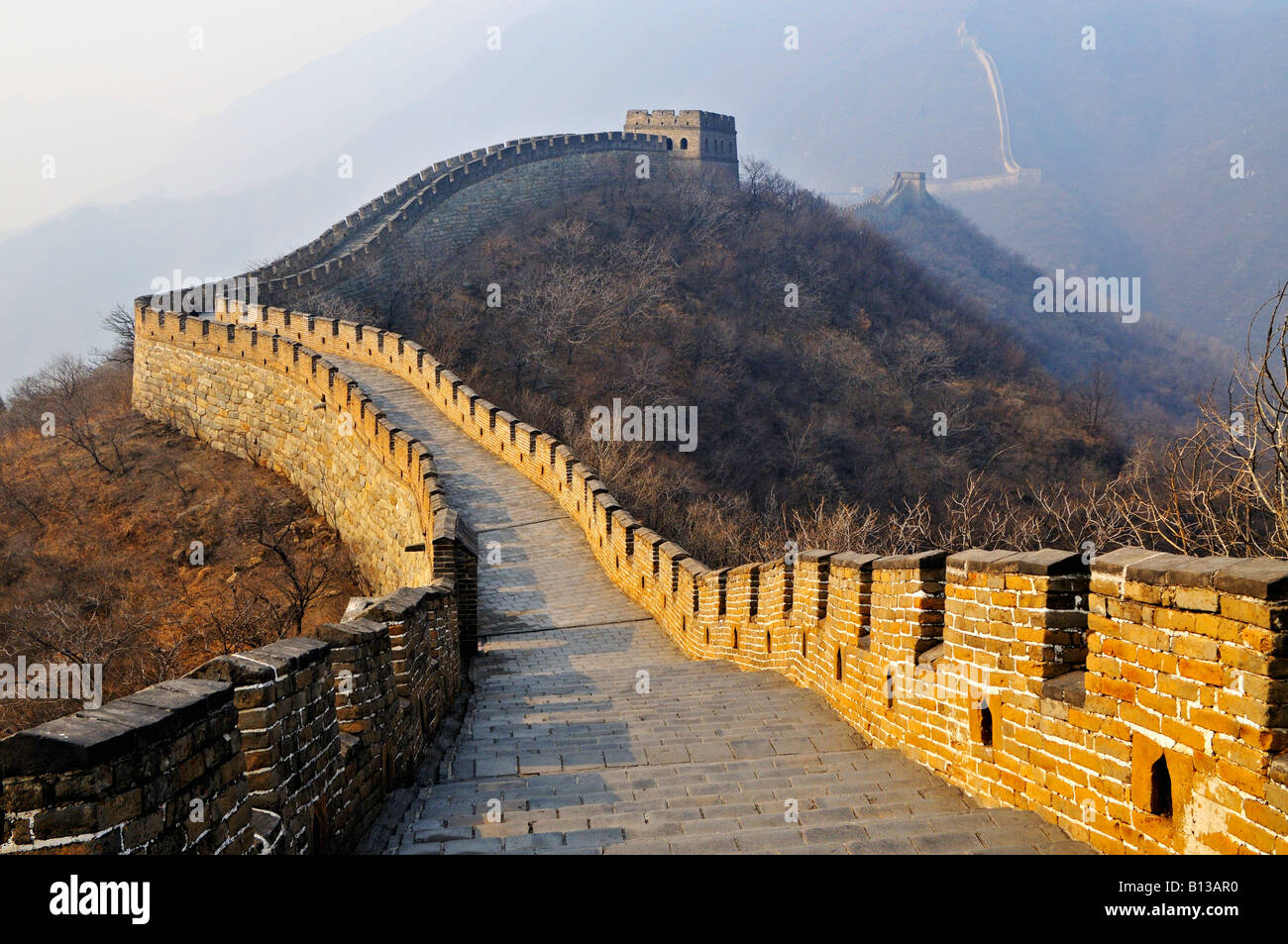 Great Wall of China with several watchtowers visible in golden late ...