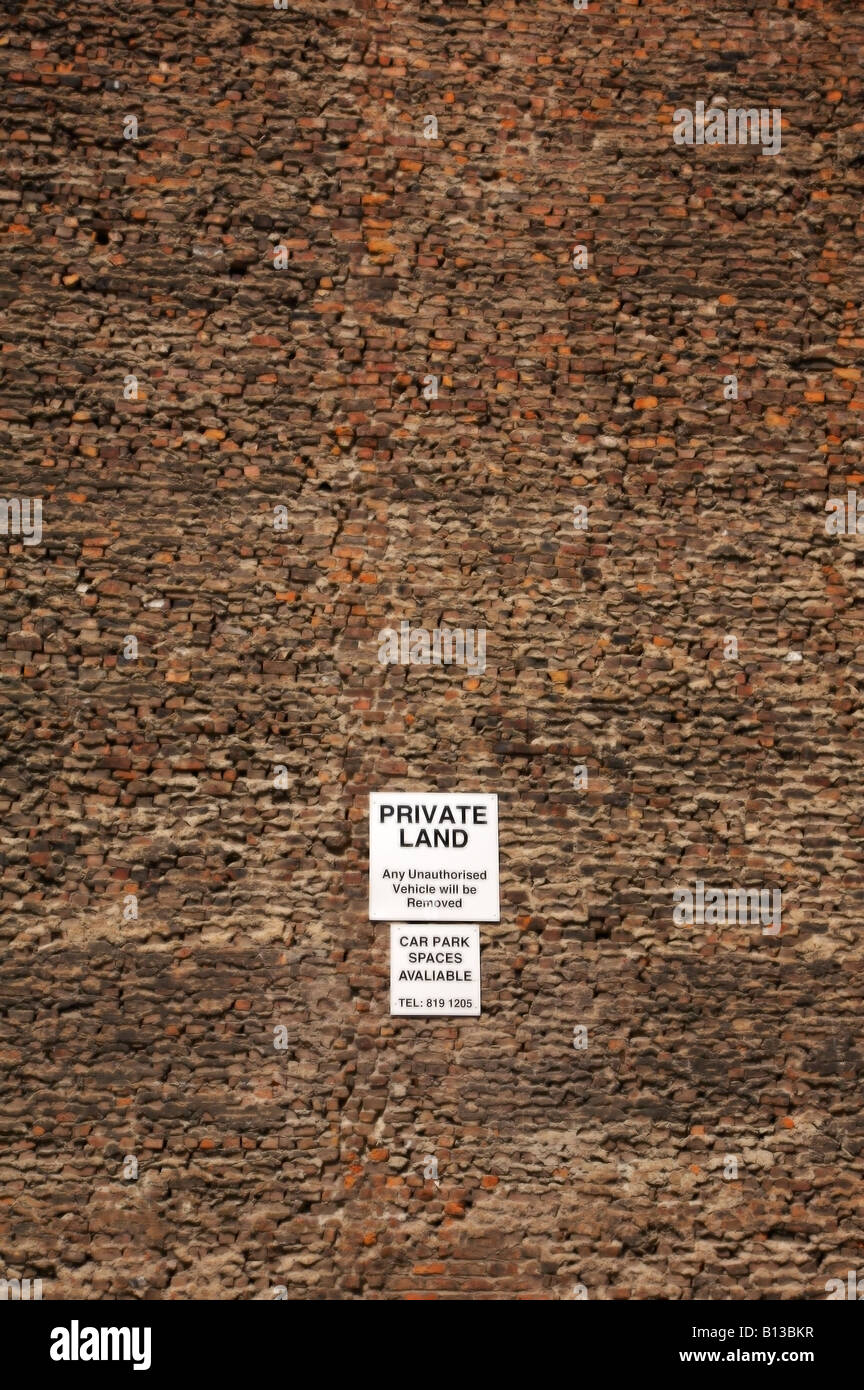 Brick wall with warning sign Stock Photo - Alamy