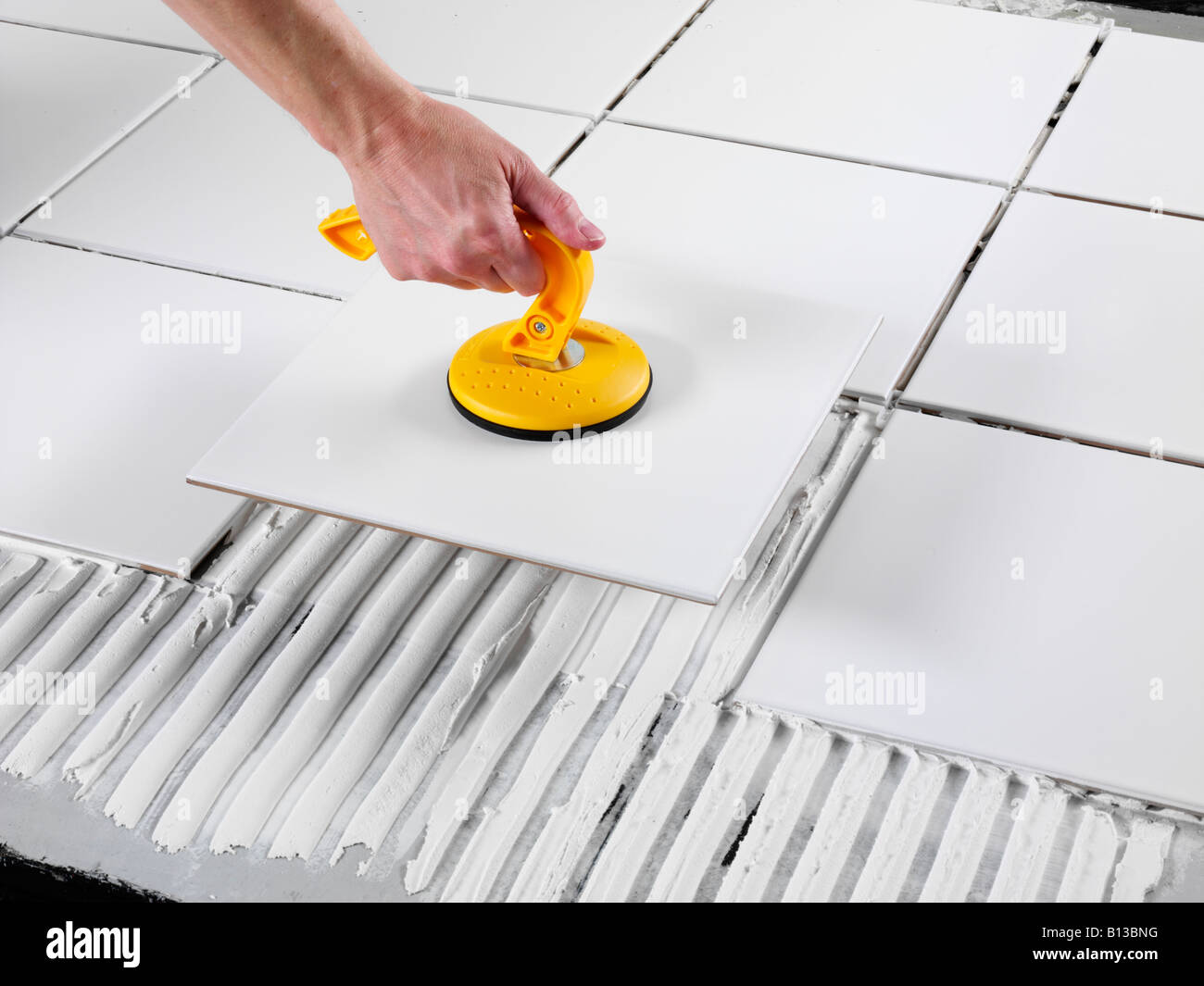 MAN TILING FLOOR Stock Photo - Alamy