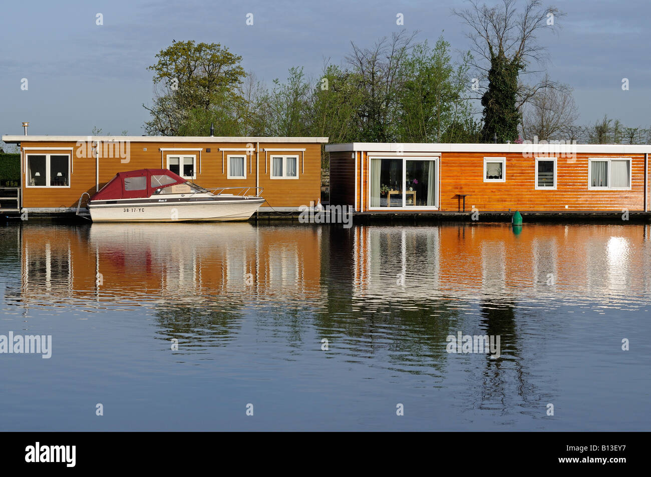 Modern Dutch houseboats reflect in Vecht river Vreeland The Netherlands ...