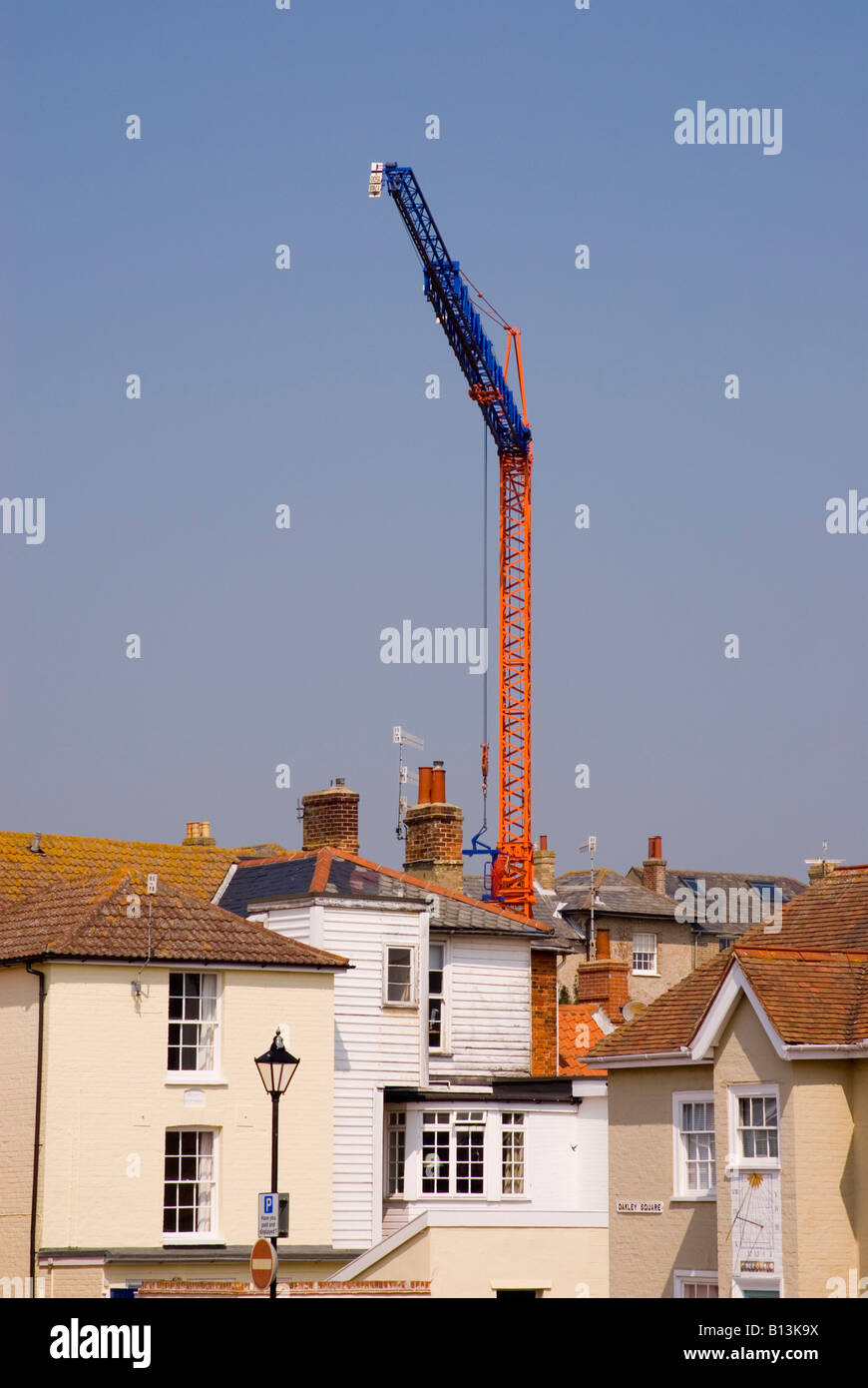 Crane Above Houses Stock Photo - Alamy
