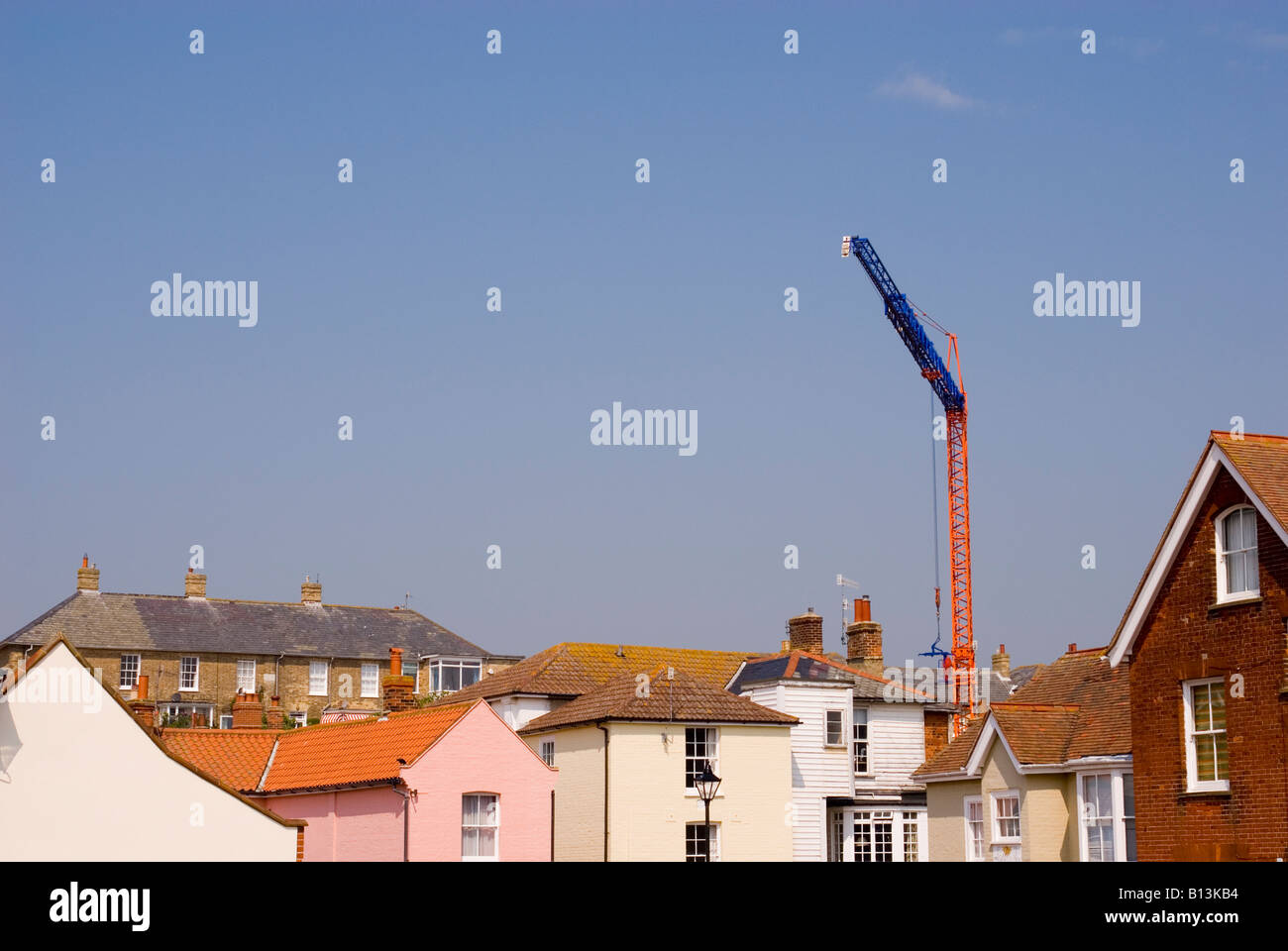 Crane Above Houses Stock Photo - Alamy