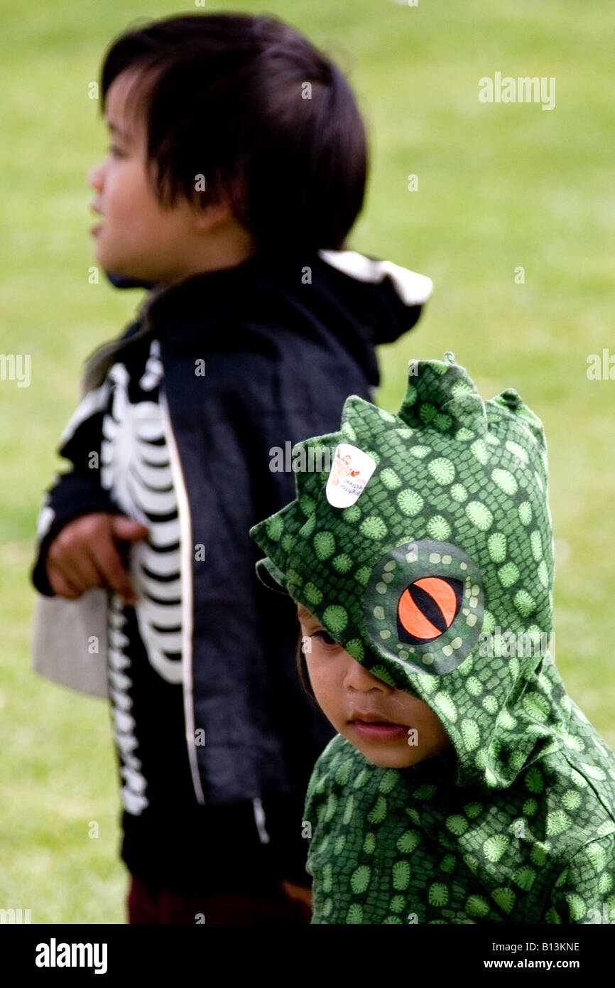 two young children dressed up as a skeleton and lizard Stock Photo - Alamy