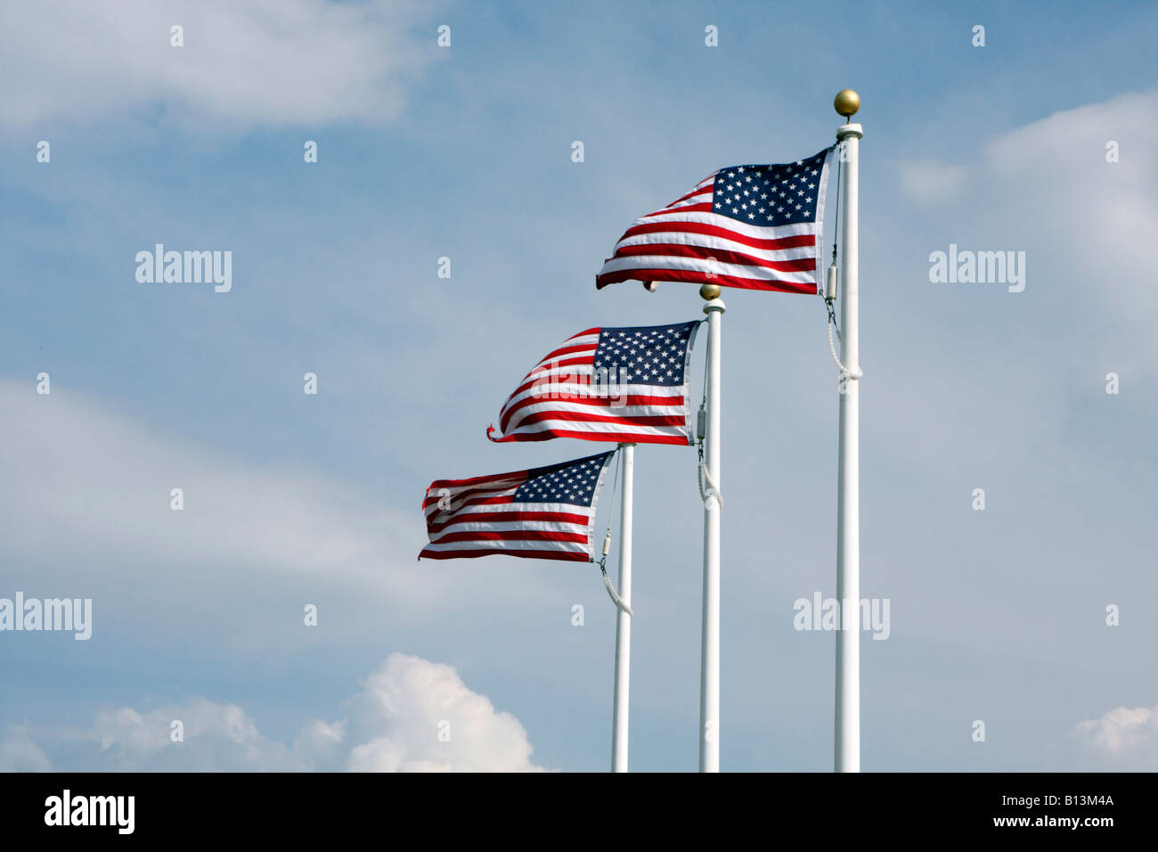 Three American Flags Waving in the wind Stock Photo - Alamy