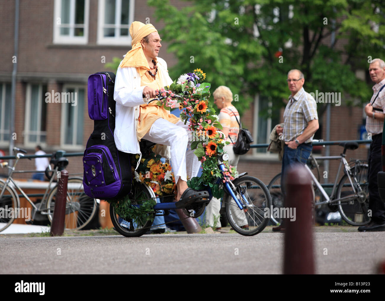 Interesting looking character cycling in Amsterdam Stock Photo - Alamy