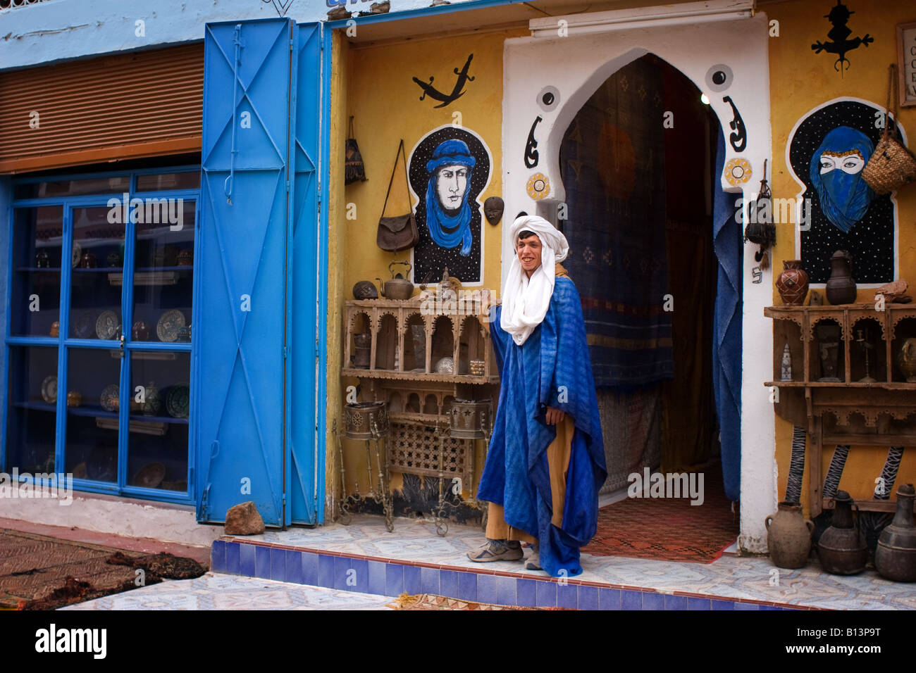 A Moroccan man and shopkeeper stands proudly outside his shop for ...