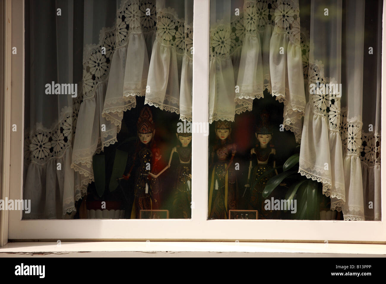 Window filled with small oriental dolls Stock Photo - Alamy
