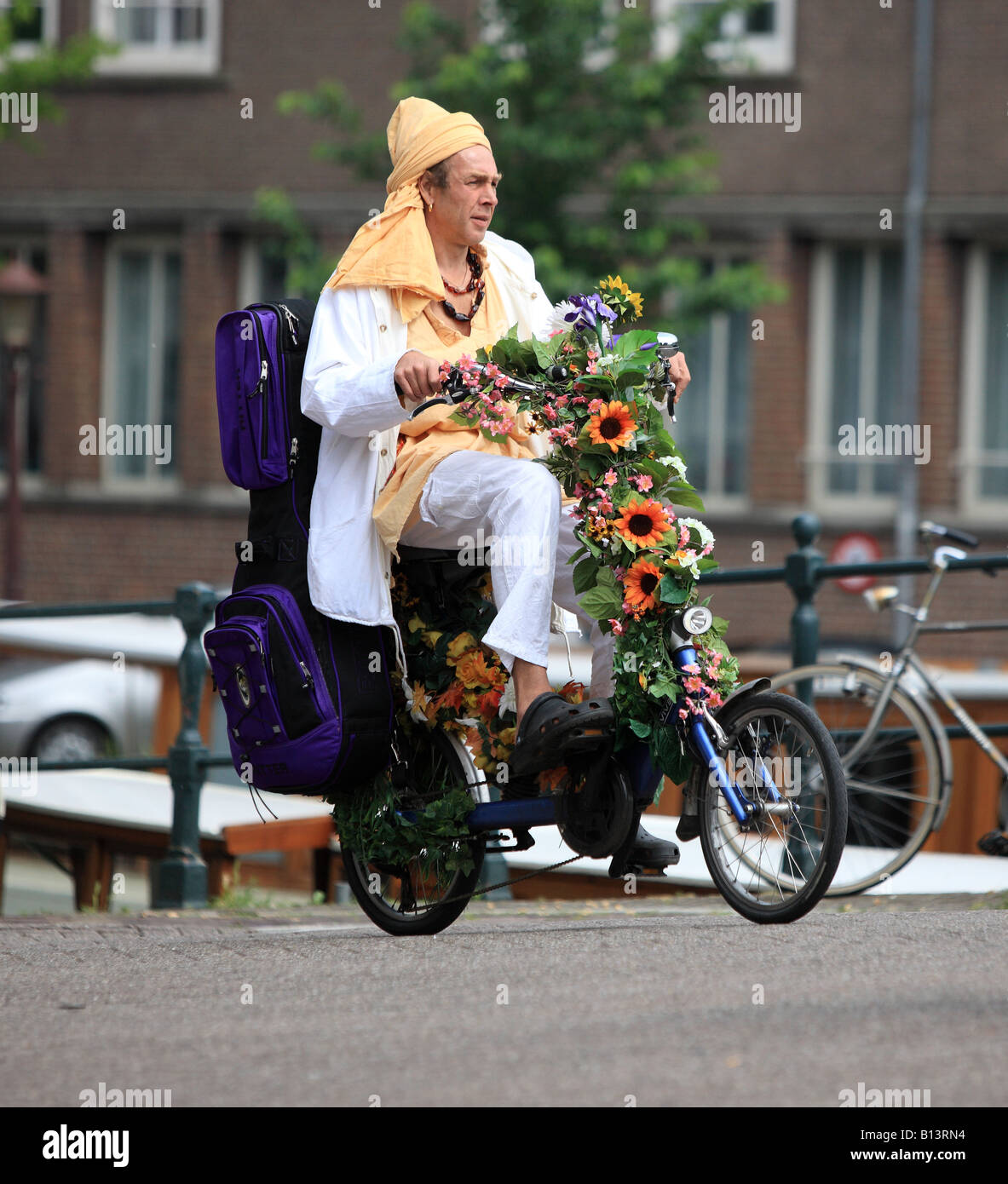 Interesting looking character cycling in Amsterdam Stock Photo - Alamy