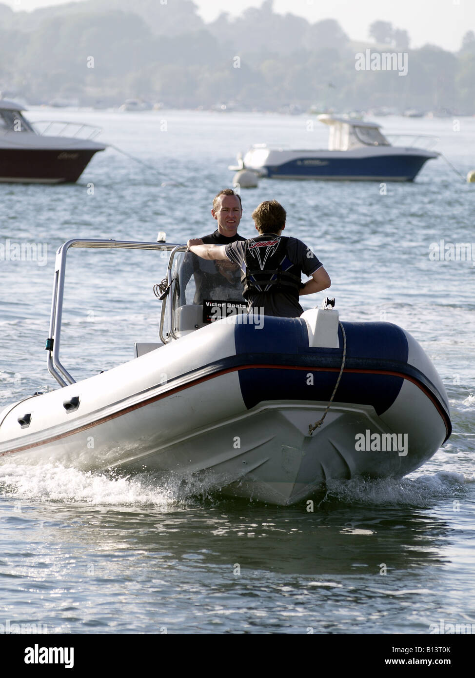 Man and teenage boy in a RIB speedboat Stock Photo - Alamy
