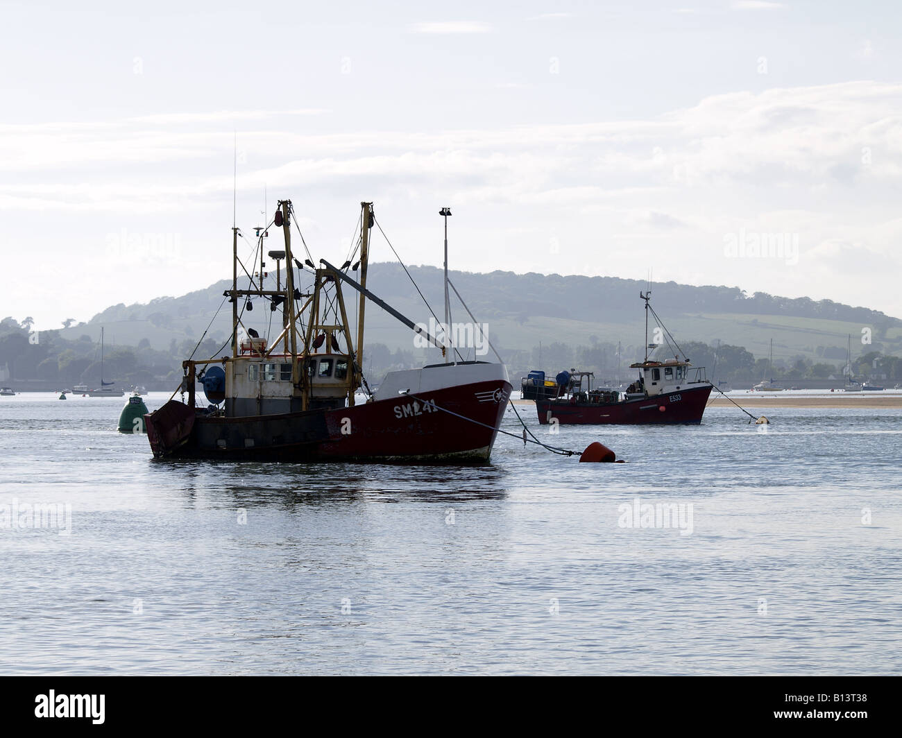 Two fishing trawlers at anchor. Devon, UK Stock Photo - Alamy