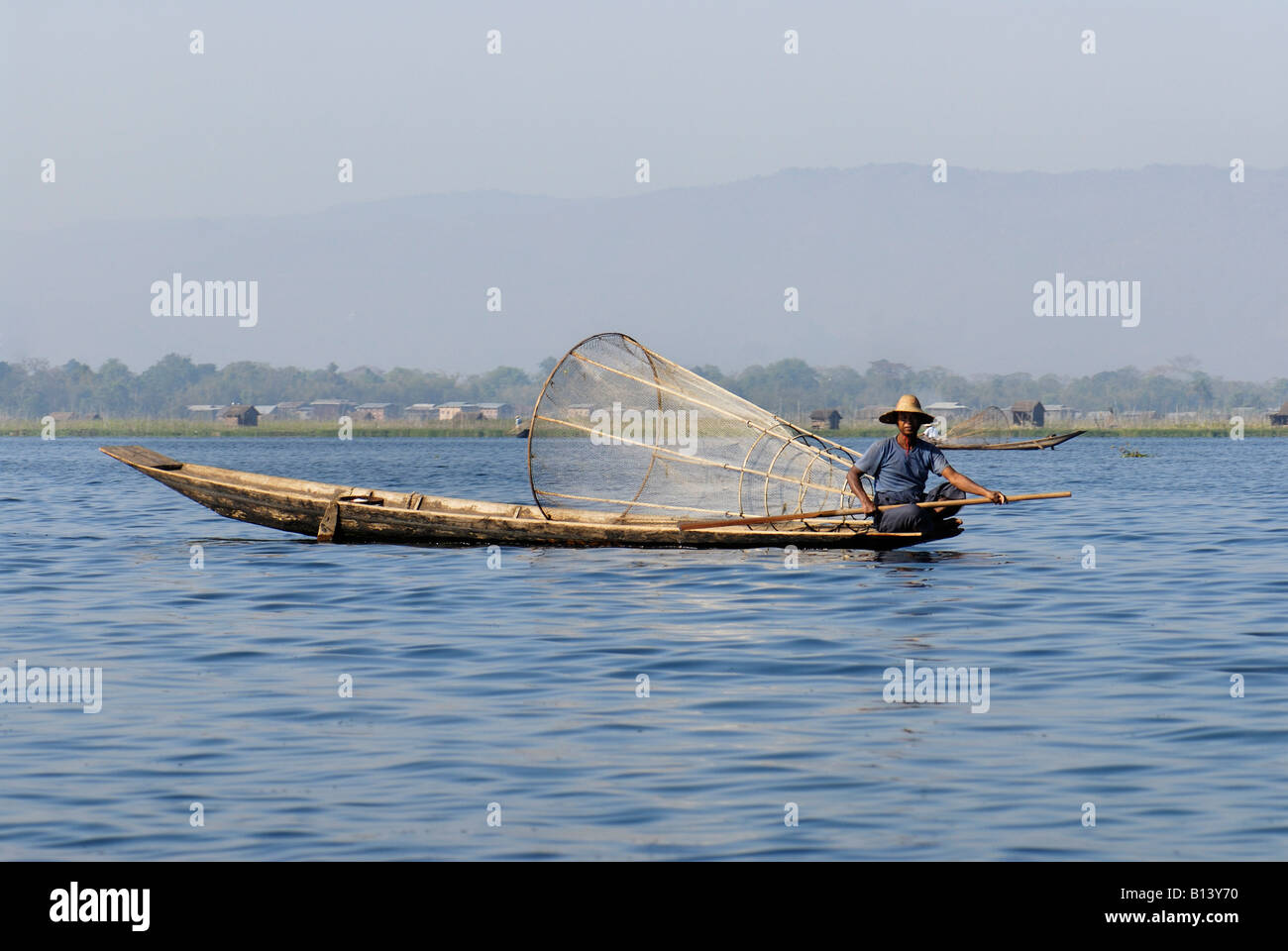 rowing boat on lake fisherman with his conical trap, Inle lake, MYANMAR ...