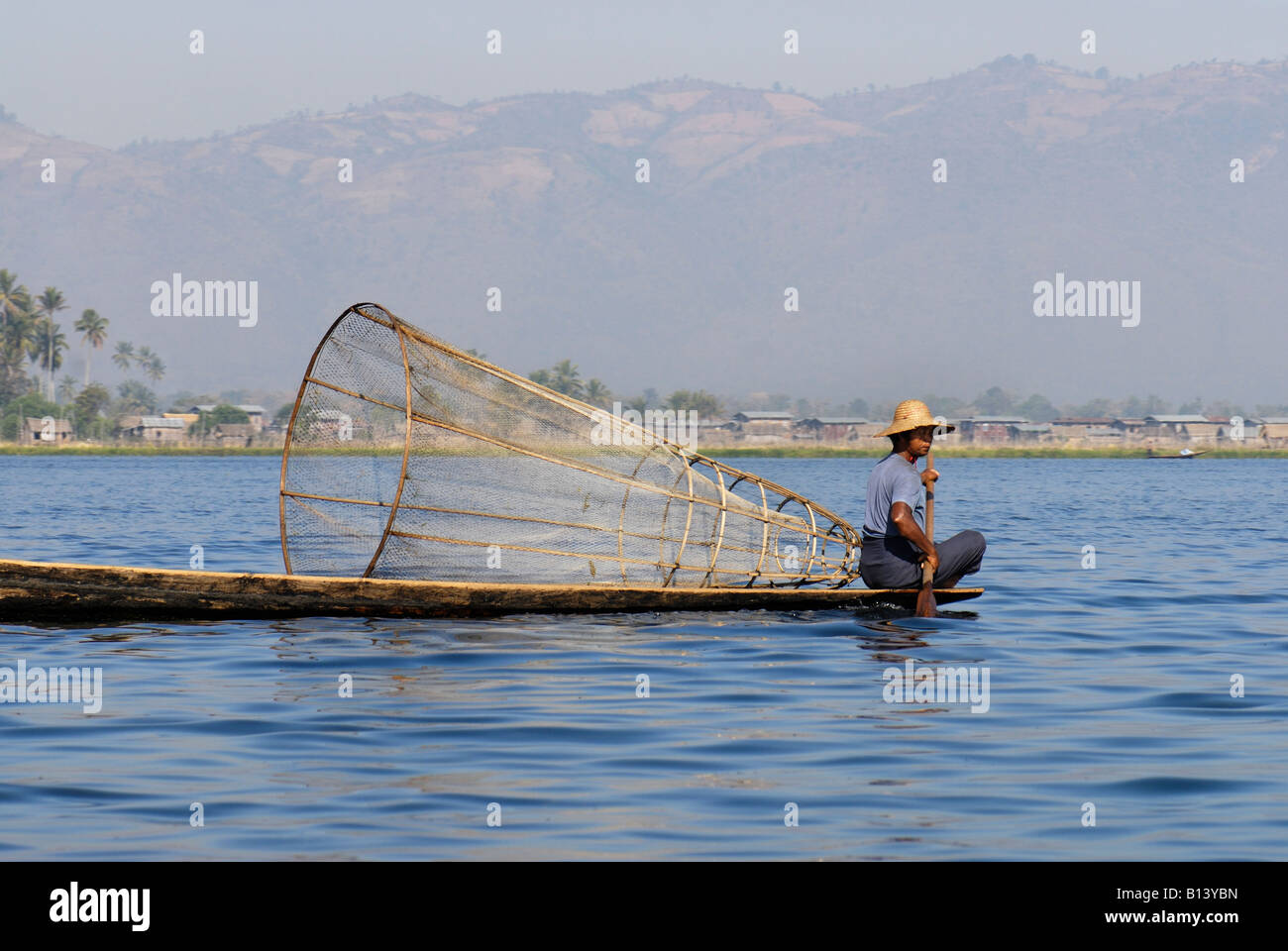rowing boat on lake fisherman with his conical trap, Inle lake, MYANMAR ...