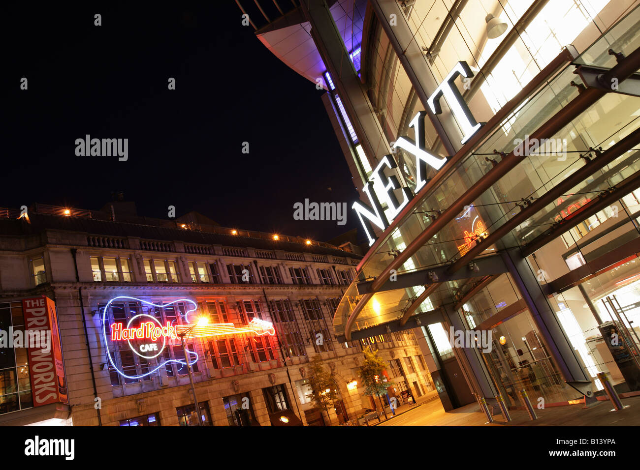 City of Manchester, England. Angled night view of the Next retail store ...