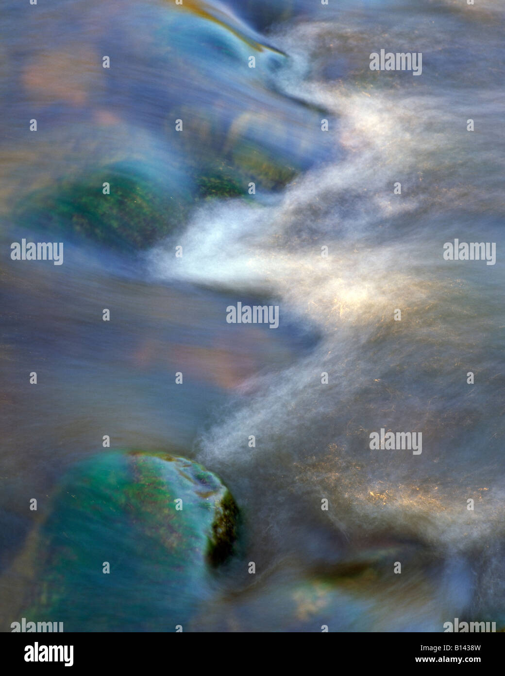 Rocks poking out of the turbulent water of the River Coquet in the ...