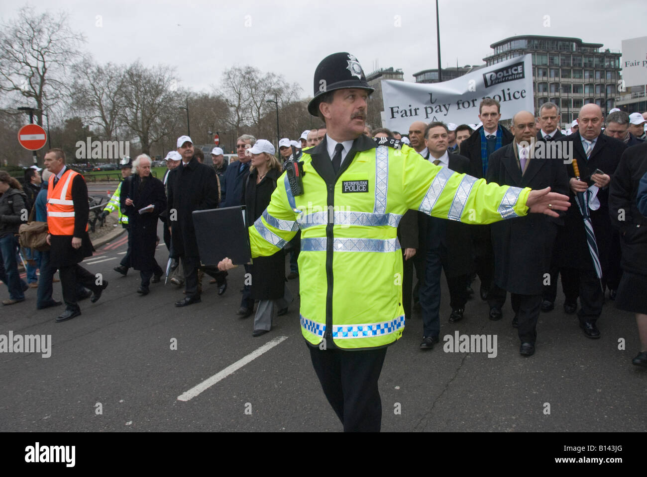 The police officer in charge of policing the police march leads it off ...